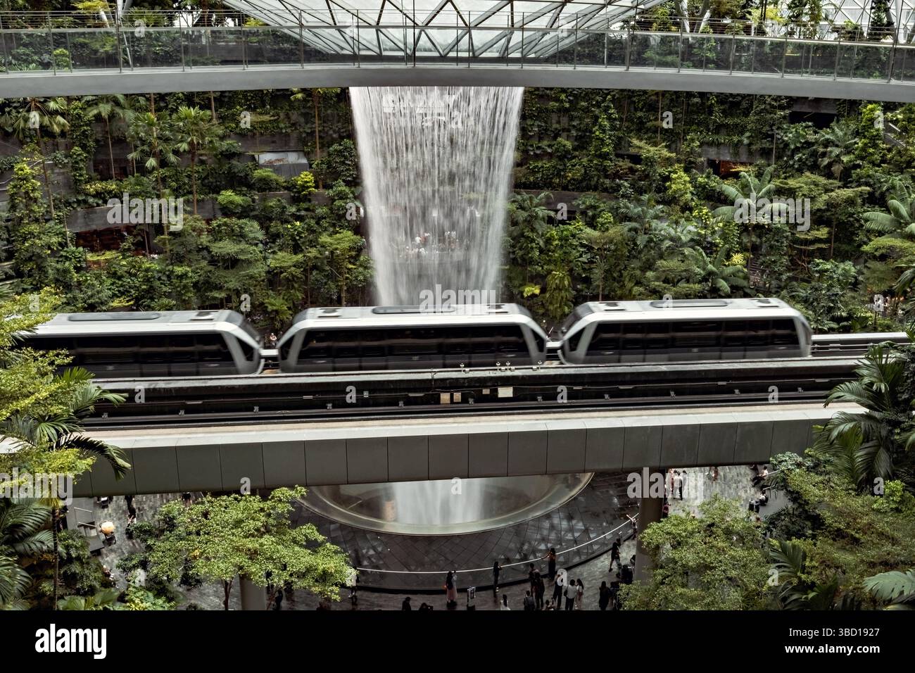 Jewel Rain Vortex waterfall and the train running in the Changi ...