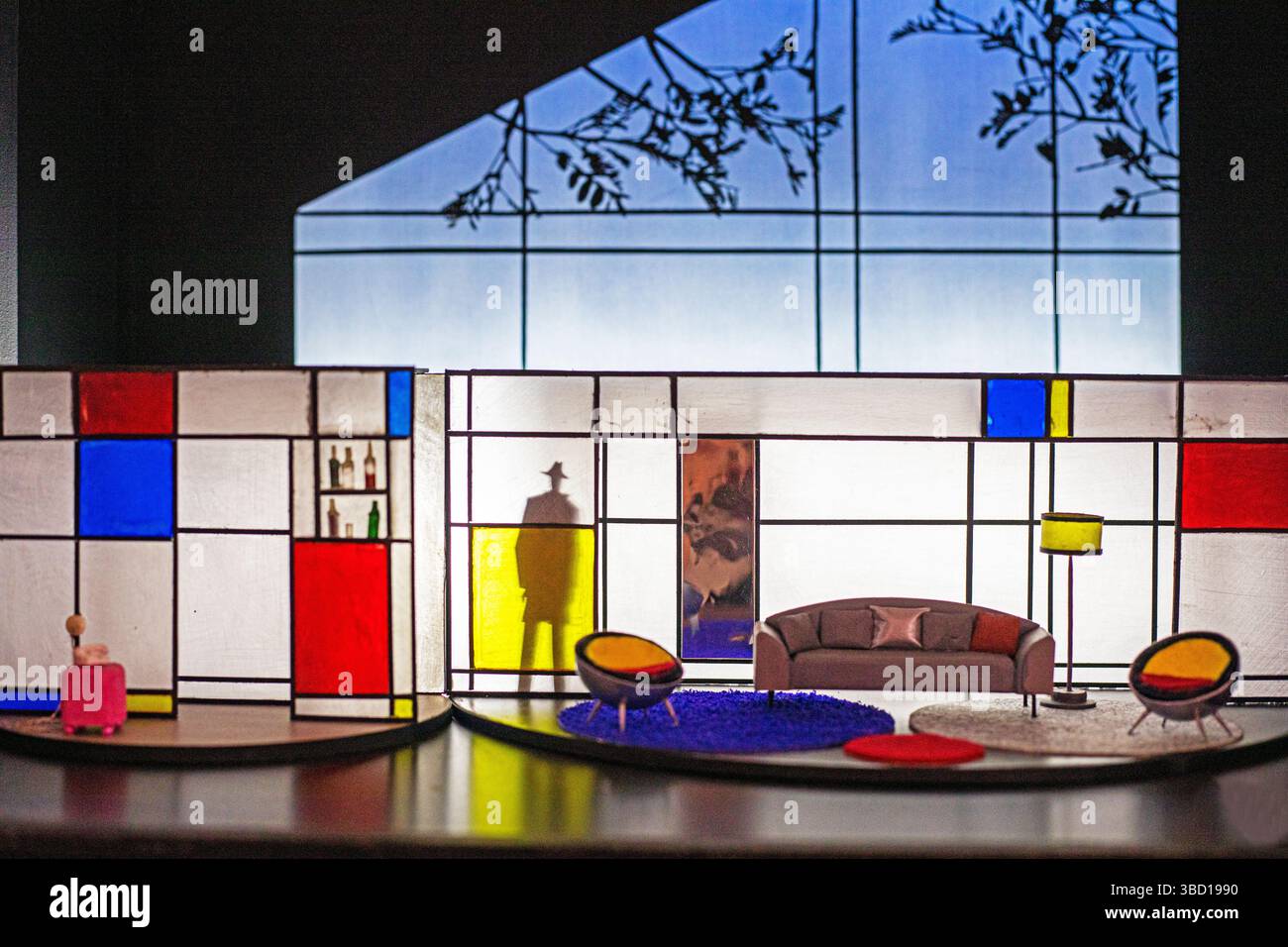 stylish interior with stained glass partitions, sofa and bright rugs ...