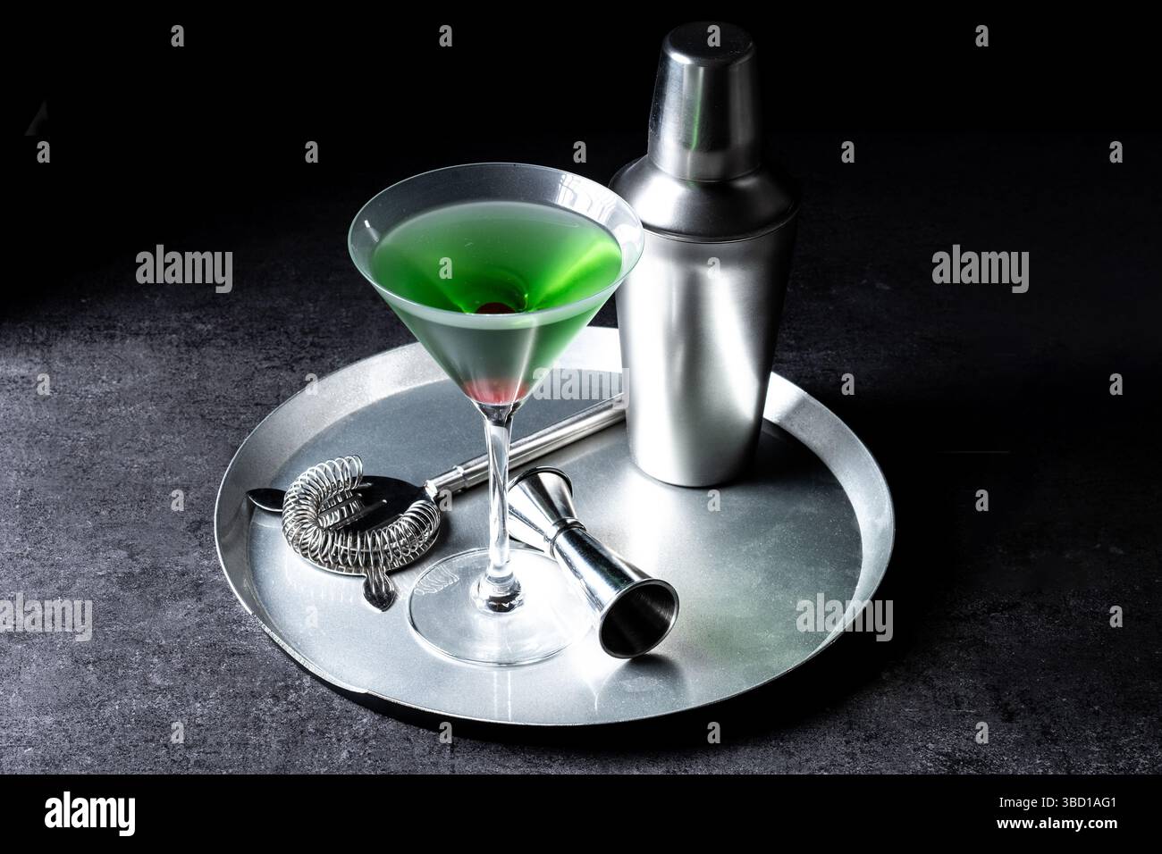 Hand catching a Japanese slipper cocktail on black background Stock Photo - Alamy