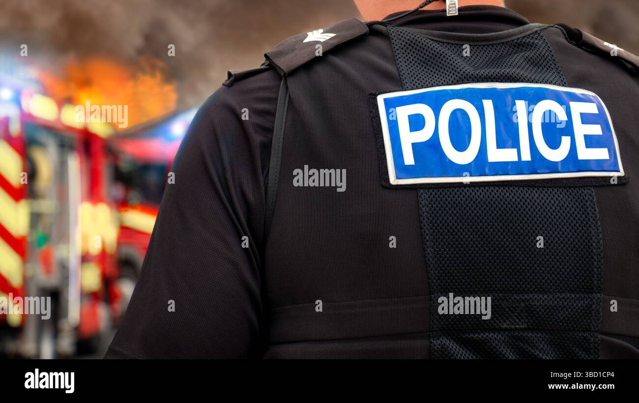 Police officer fire investigation by emergency services fire engines ...