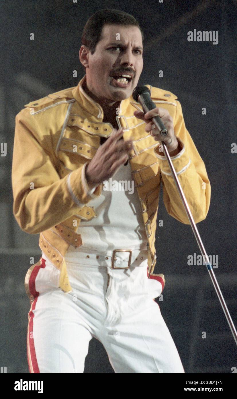 The lead singer of the band Queen, Freddie Mercury, singing during an ...