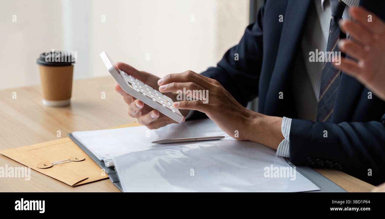Business Analysis and Calculation. Professional using a calculator ...