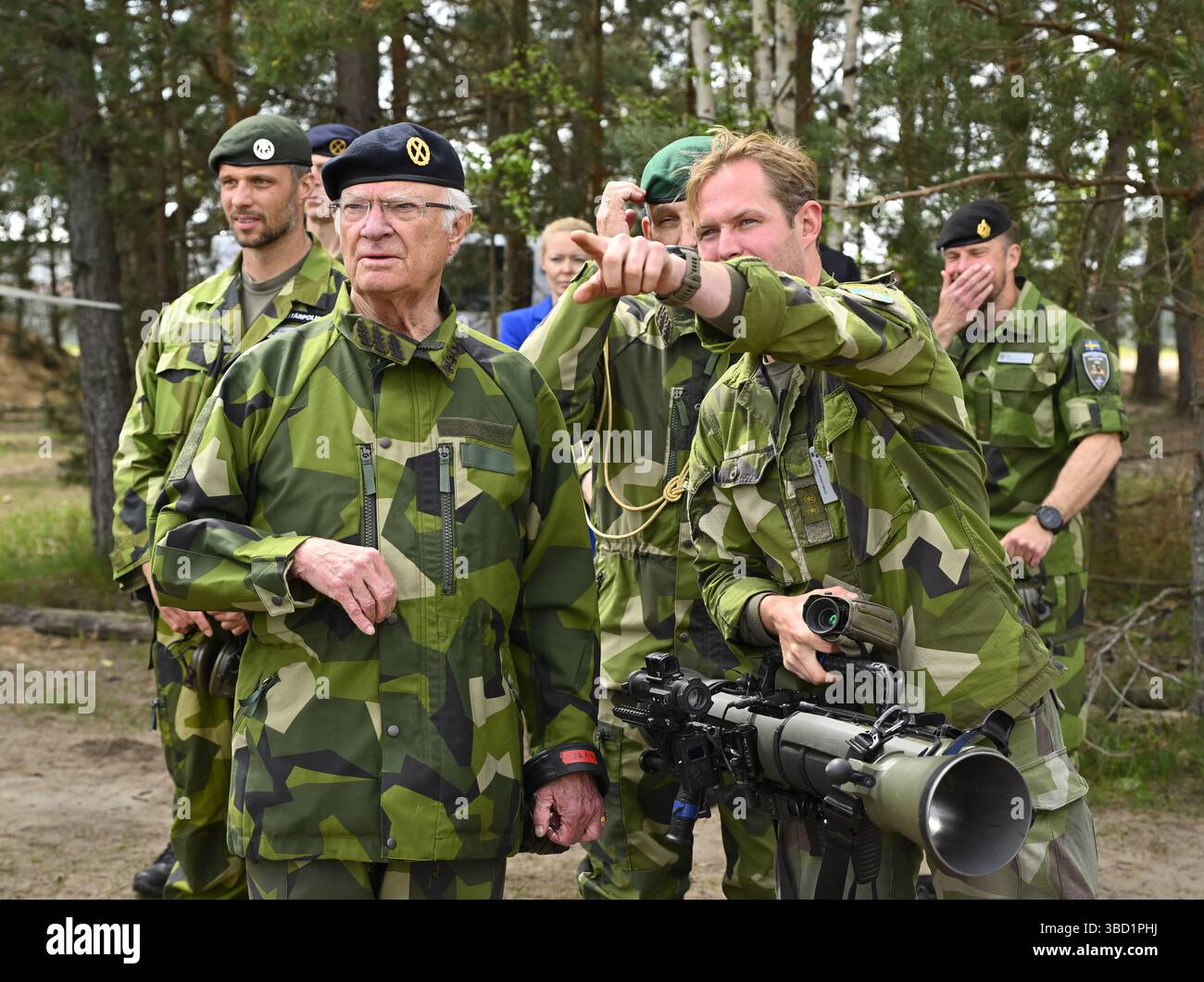King Carl Gustaf of Sweden is shown the Carl Gustaf 84 mm grenade ...