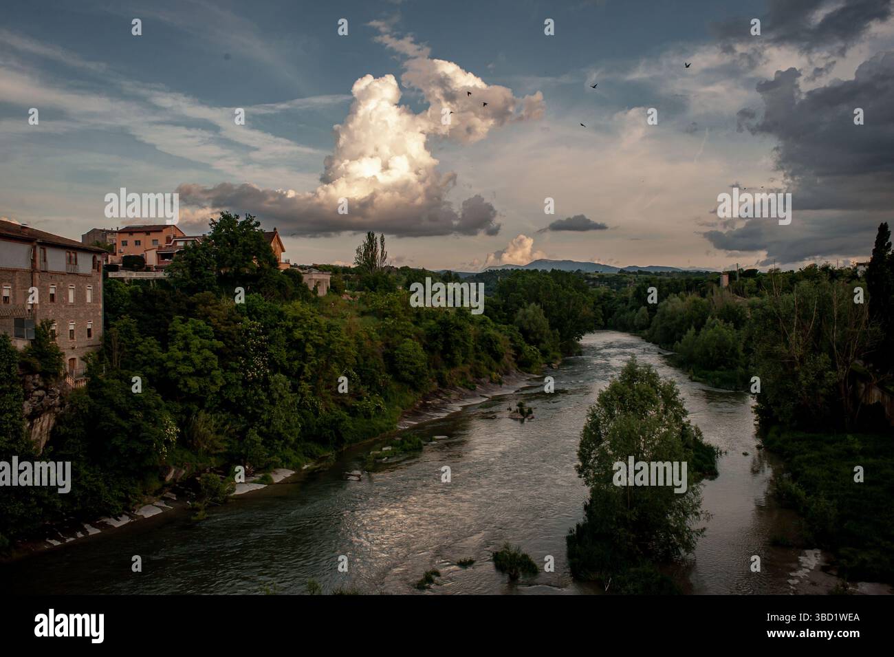 The Ter River flows abundantly crossing Roda de Ter village as ...