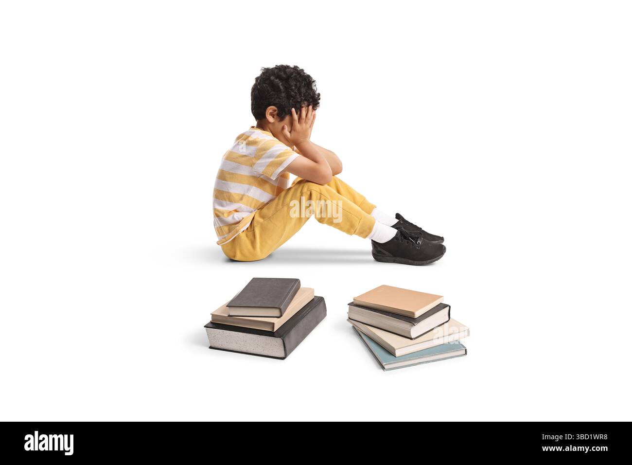 Sad kid sitting on the floor with books isolated on white background ...