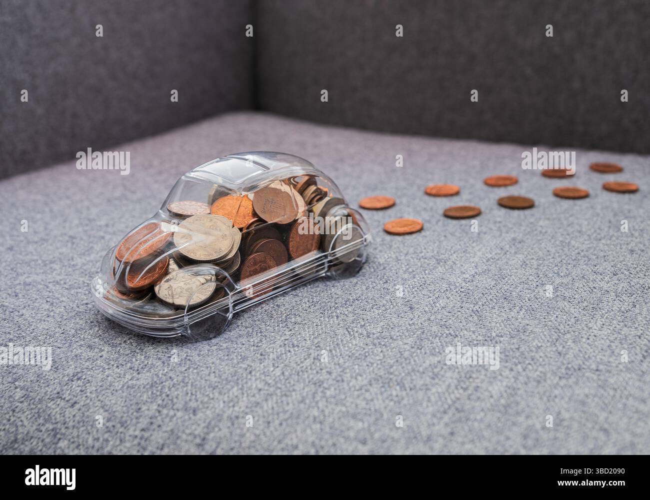 Saving on the Move Coins and Toy Car Stock Photo - Alamy