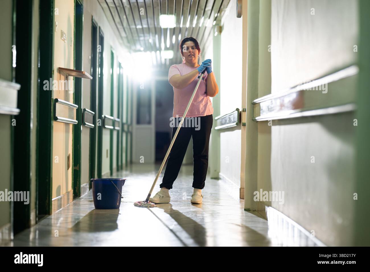 Cleaning Staff in Hospital Hallway.Female janitor standing in a ...
