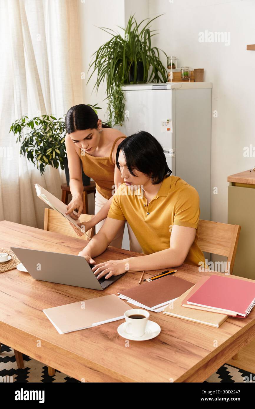 A man and woman collaborate on a project at their home, enjoying love ...