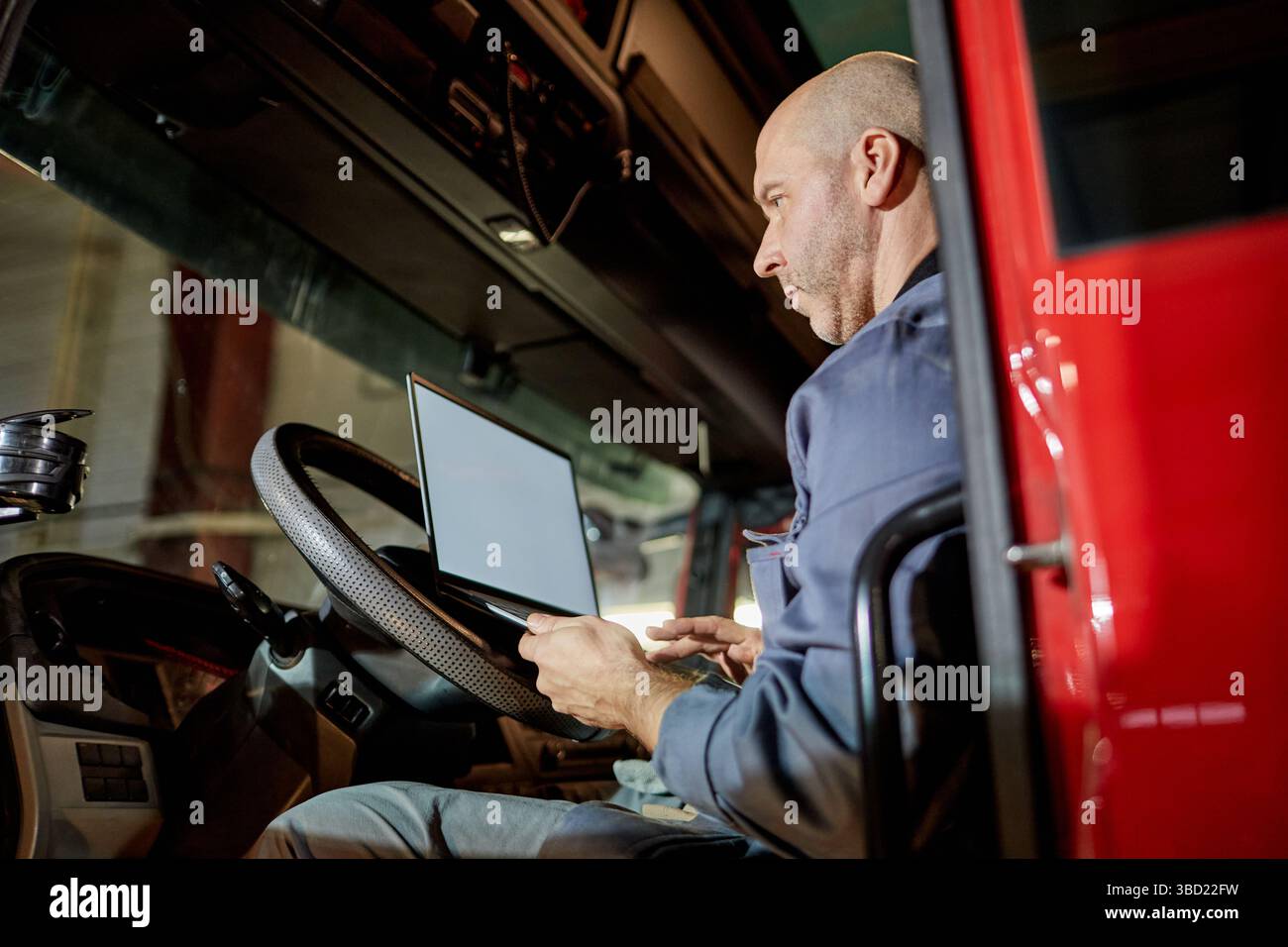 Professional Truck Driver Using Onboard Technology Stock Photo - Alamy
