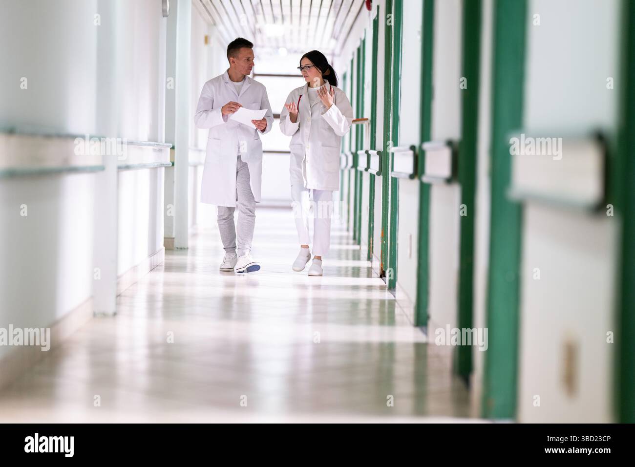 Doctors Walking in Hospital Hallway Stock Photo - Alamy