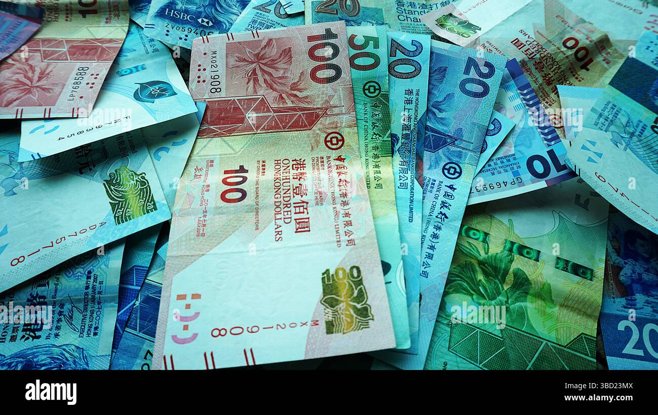 Various denominations of Hong Kong dollars stacked, with a 100-dollar ...