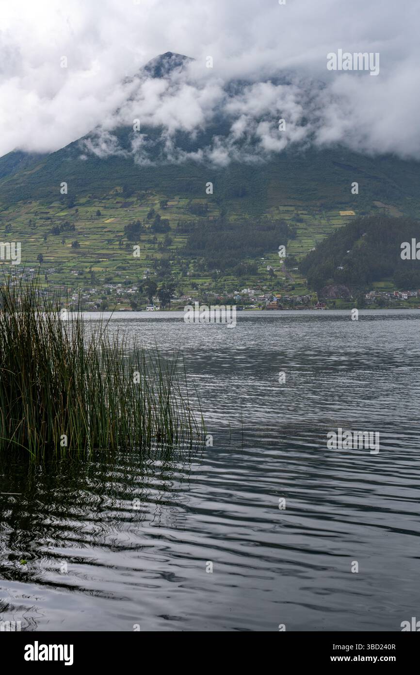 Lago San Pablo with cloud-covered Imbabura Volcano behind, near Otavalo ...