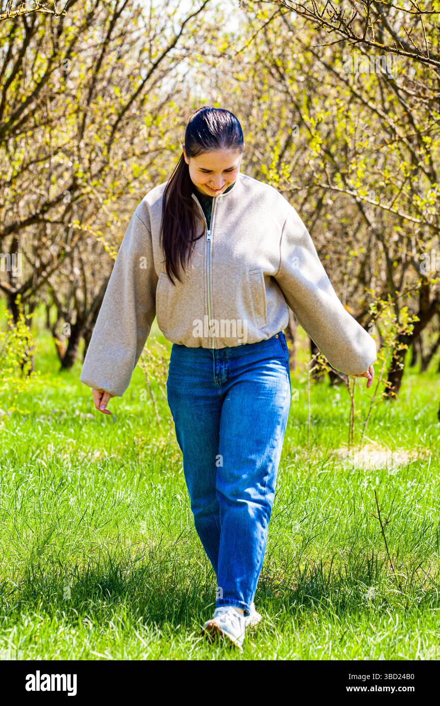 Picture of an almond orchard while a very beautiful and attractive girl ...