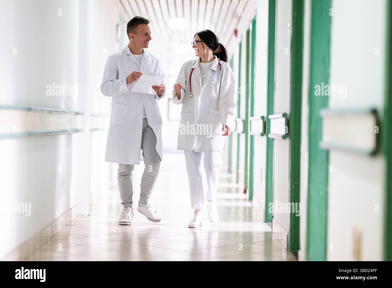 Doctors Walking in Hospital Hallway Stock Photo - Alamy