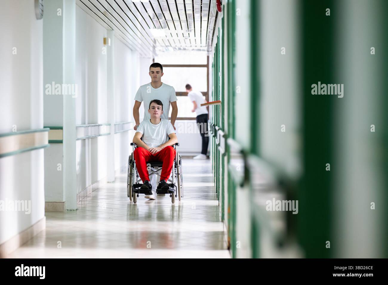 Hospital Staff with Wheelchair in Hallway Stock Photo - Alamy