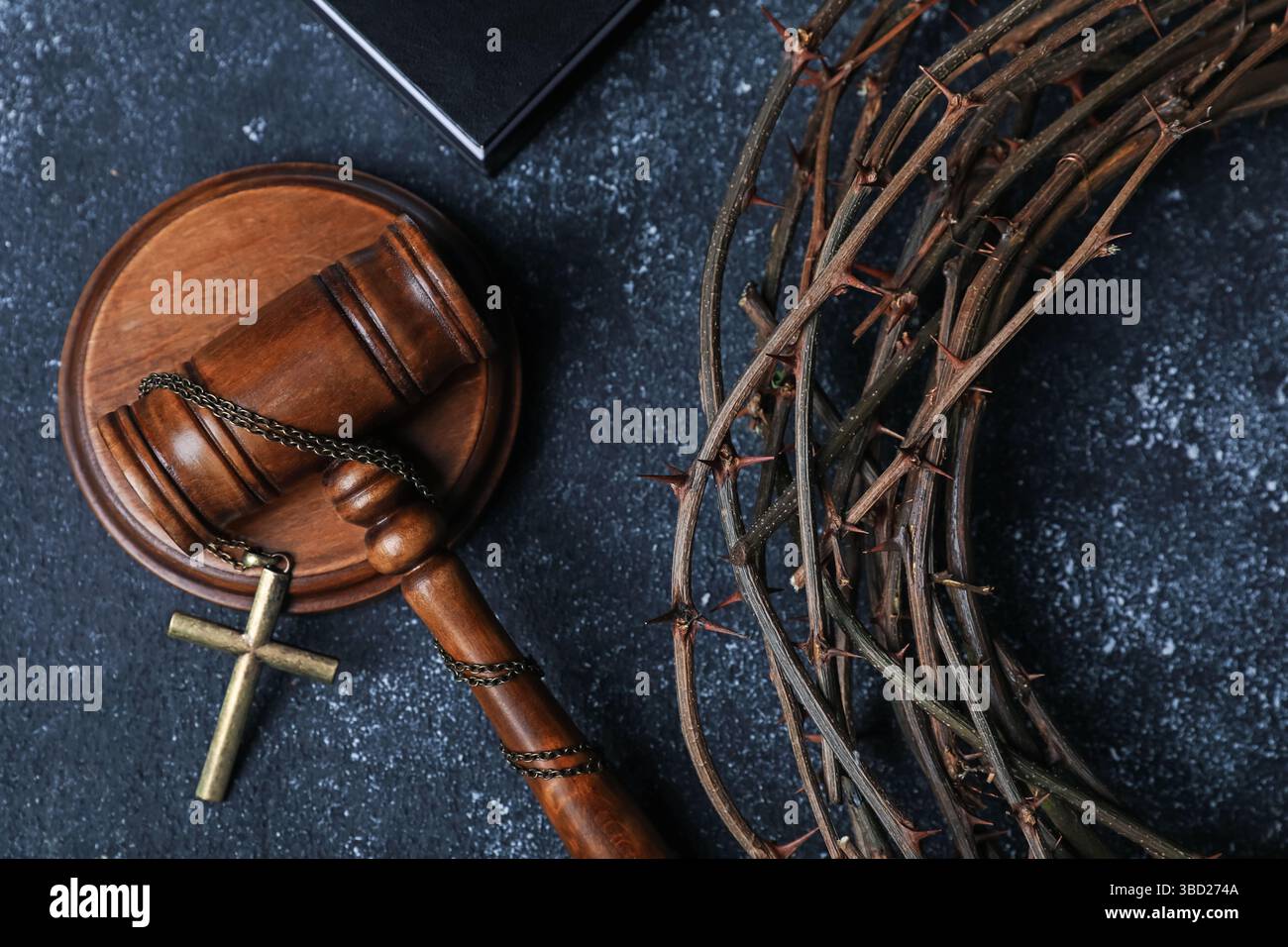 Crown of thorns and judge's gavel with cross on dark textured ...