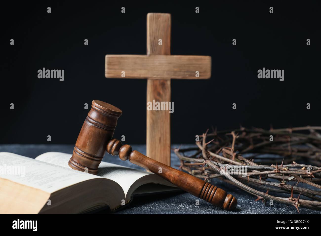 Crown of thorns, judge's gavel, Bible and wooden cross on dark textured ...