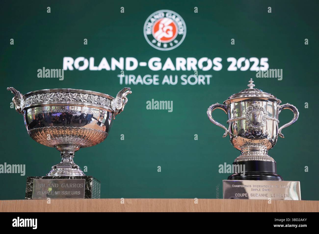 The men's, left, and women's trophies are displayed during the draw of ...