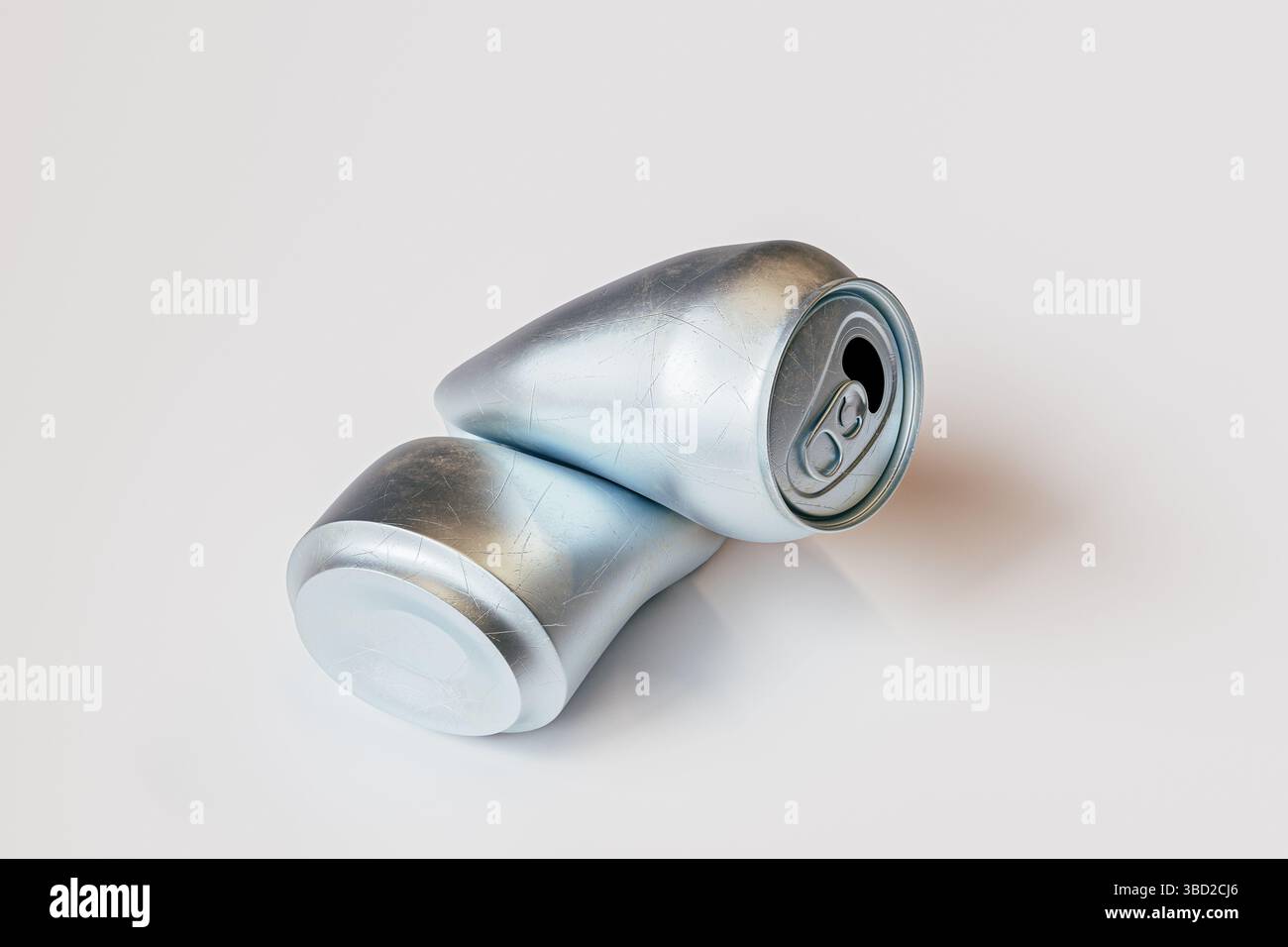 Can of soda is laying on a white surface. The can is crumpled and ...