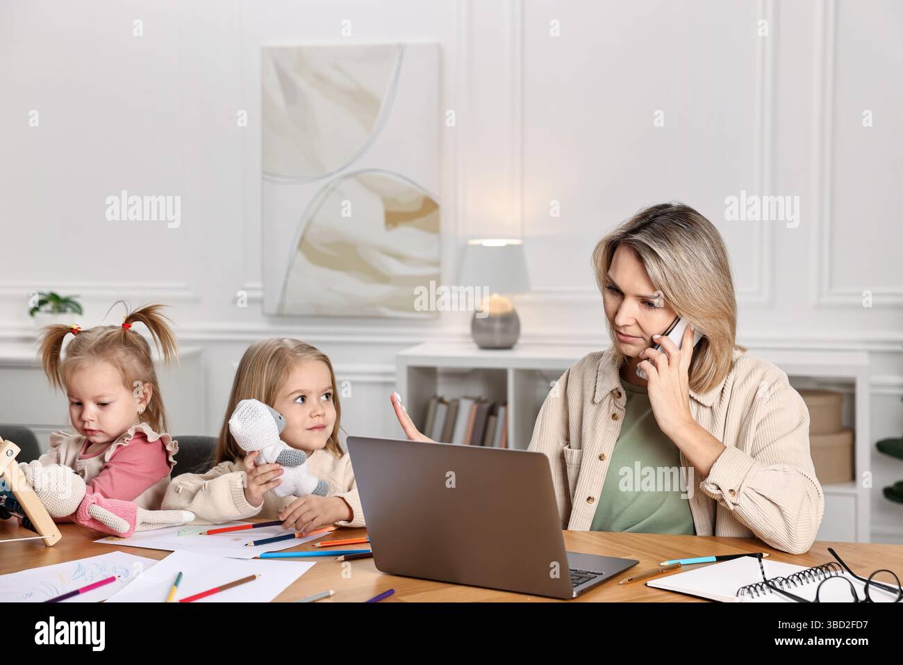 Work-family balance. Single mother talking by smartphone and refusing ...