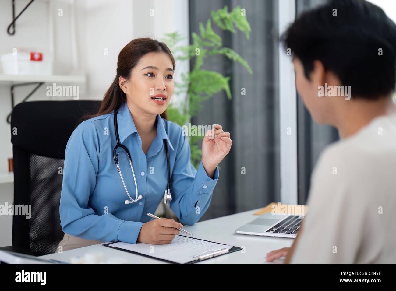 Health and Wellness. Doctor explaining health issues to a patient in a ...