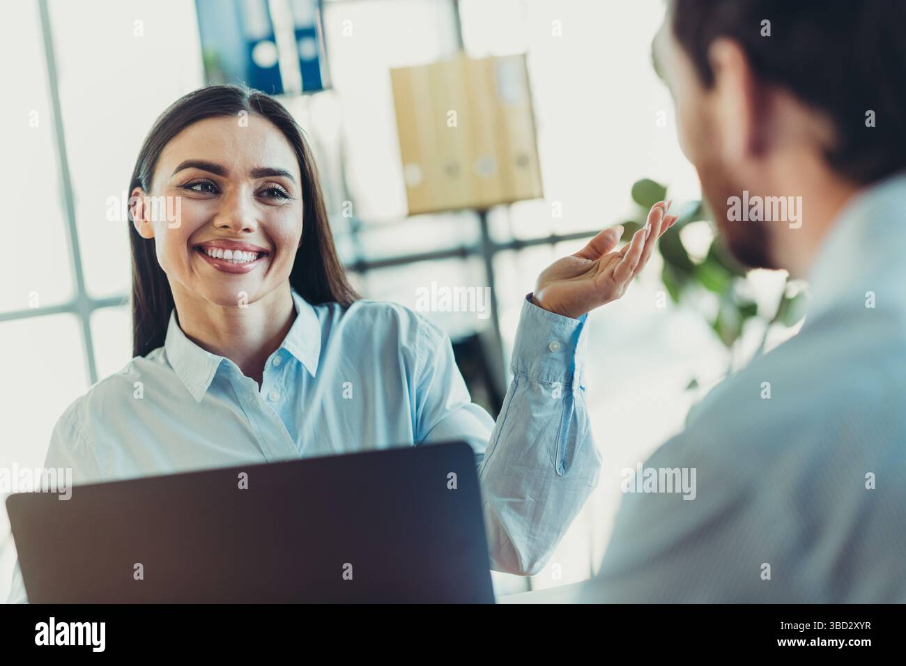 Professionals engaged in a job interview exchanging positive gestures ...