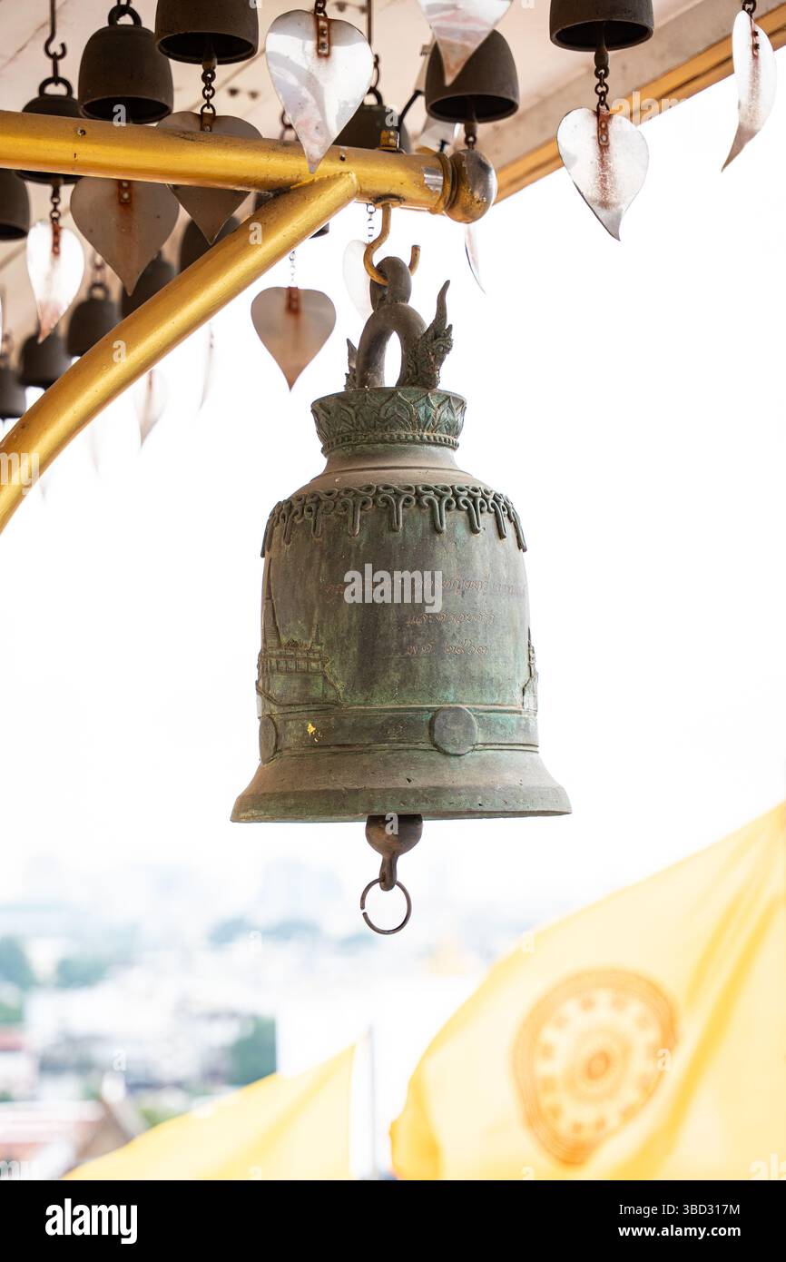 Close-up of a bronze temple bell with engraved Thai motifs at Wat Saket ...