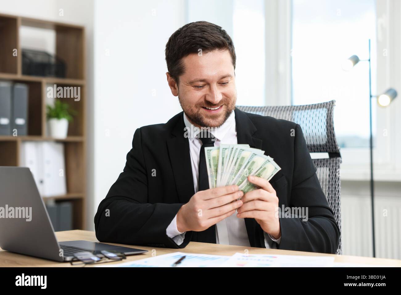 Greedy banker counting money hi-res stock photography and images - Alamy
