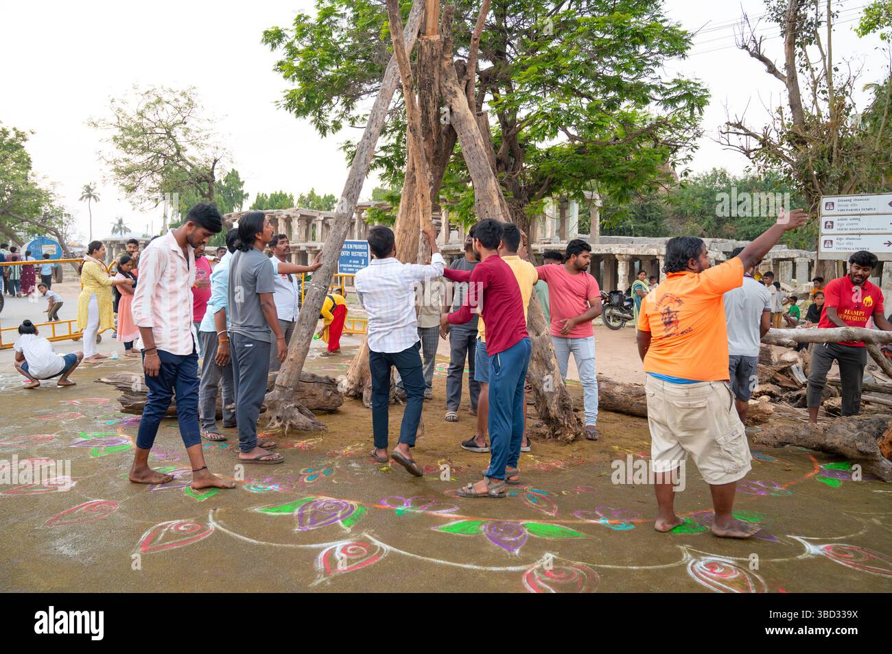 Holika Dahan, men collect wood for ritual bonfire, Kolam colorful ...