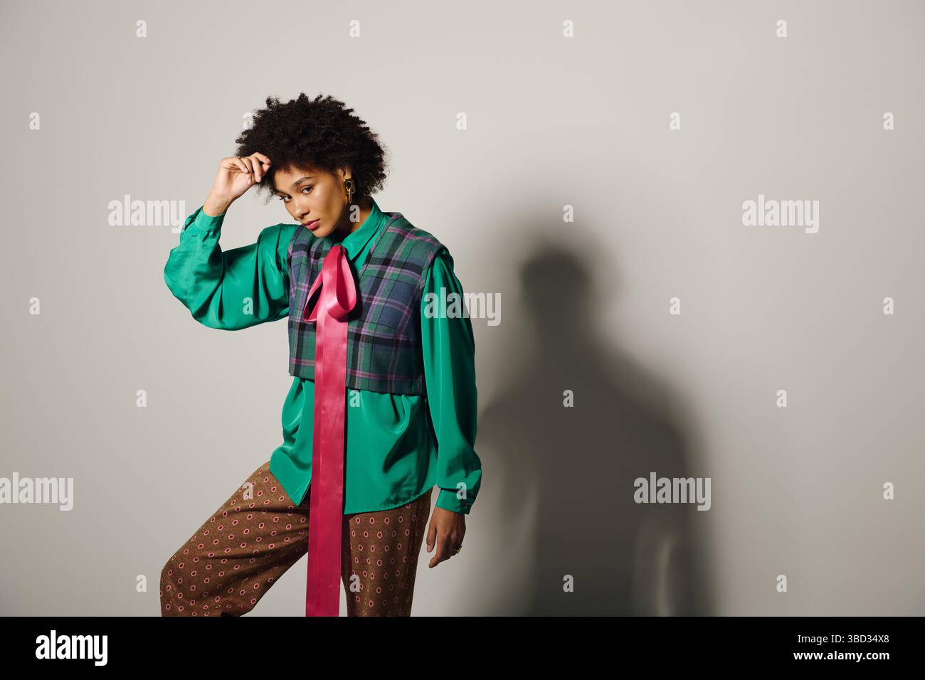 Stylish woman poses confidently while displaying a unique outfit with ...