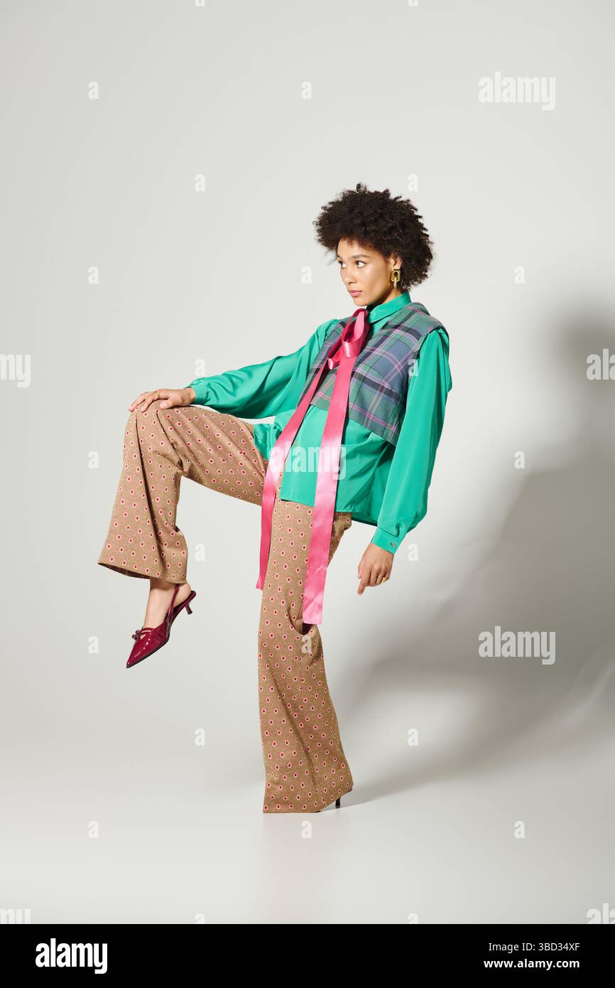 Confident young woman poses with flair, showcasing her vibrant outfit ...