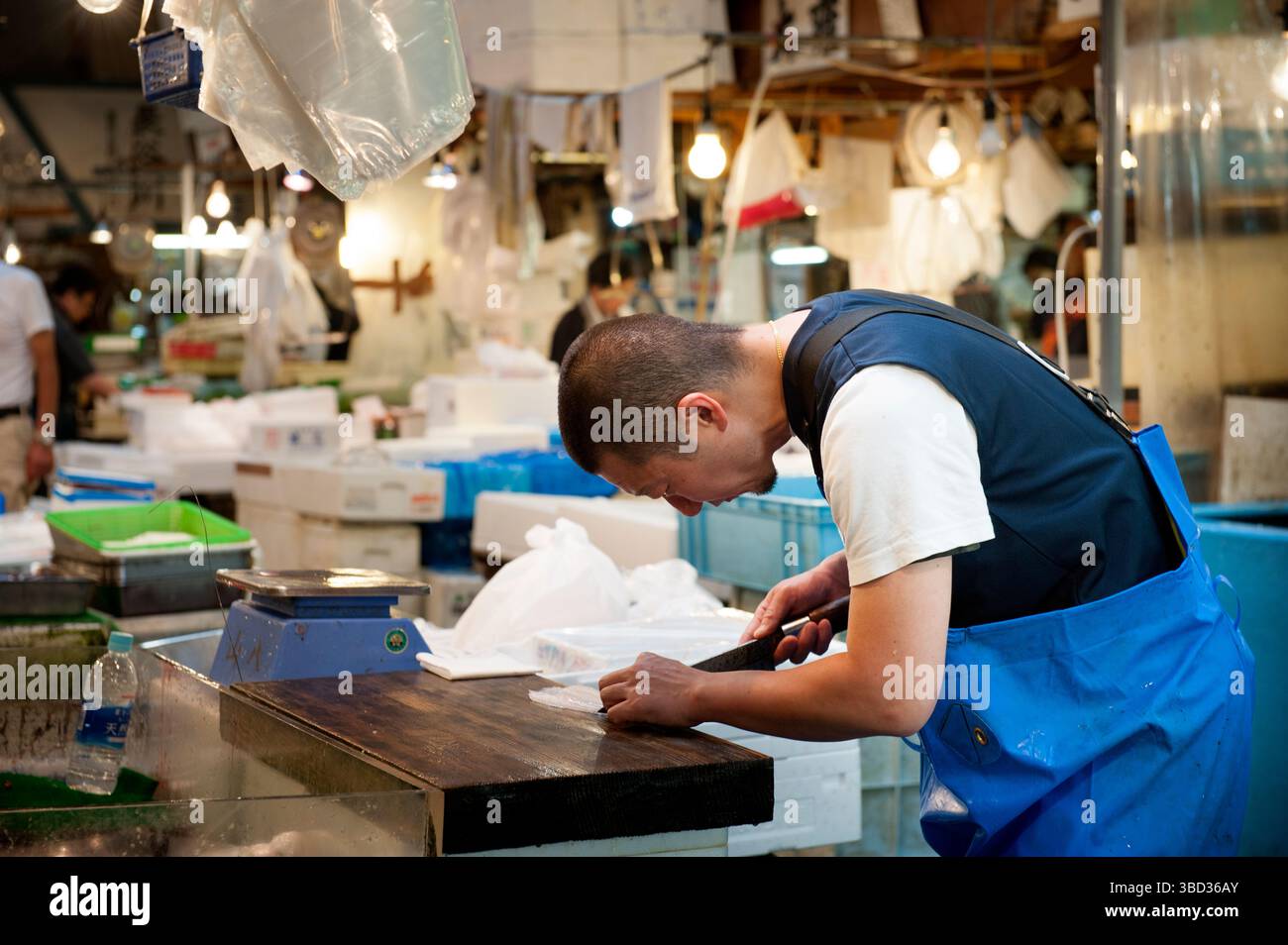 Worker slicing fish at the fish market, Tokyo, Japan. Tokyo, officially ...
