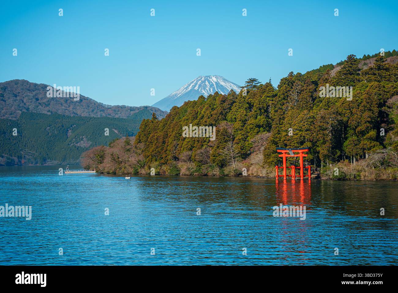 Peaceful morning scene in Hakone, Japan, featuring Lake Ashi, a red ...