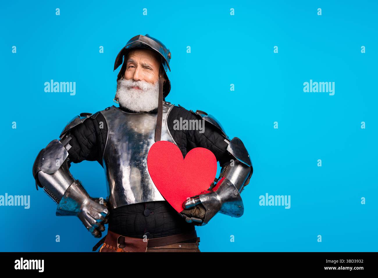 Elderly knight in shining armor holding heart symbol with a confident ...