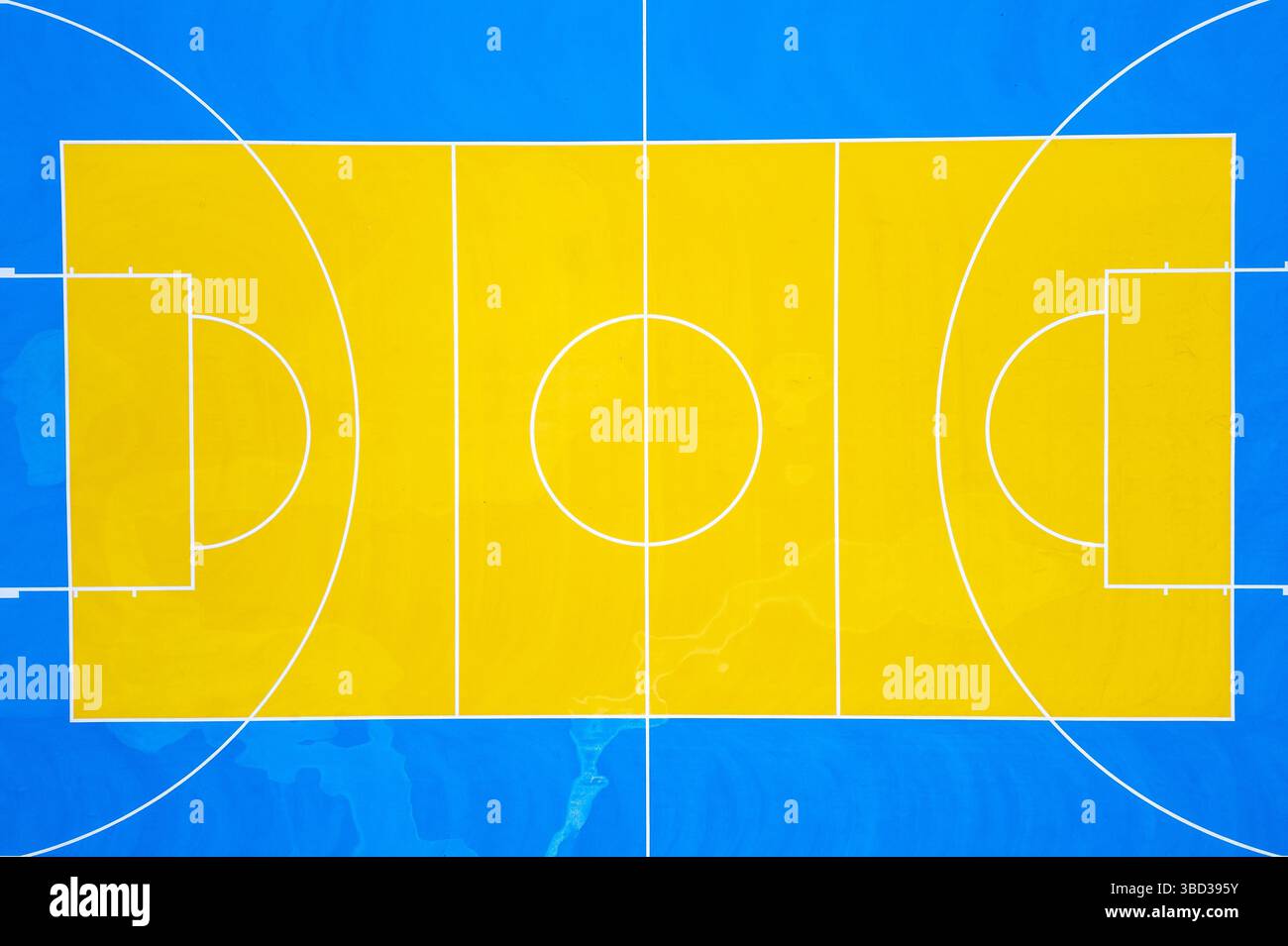 Aerial view of a colorful outdoor basketball court with vibrant blue ...