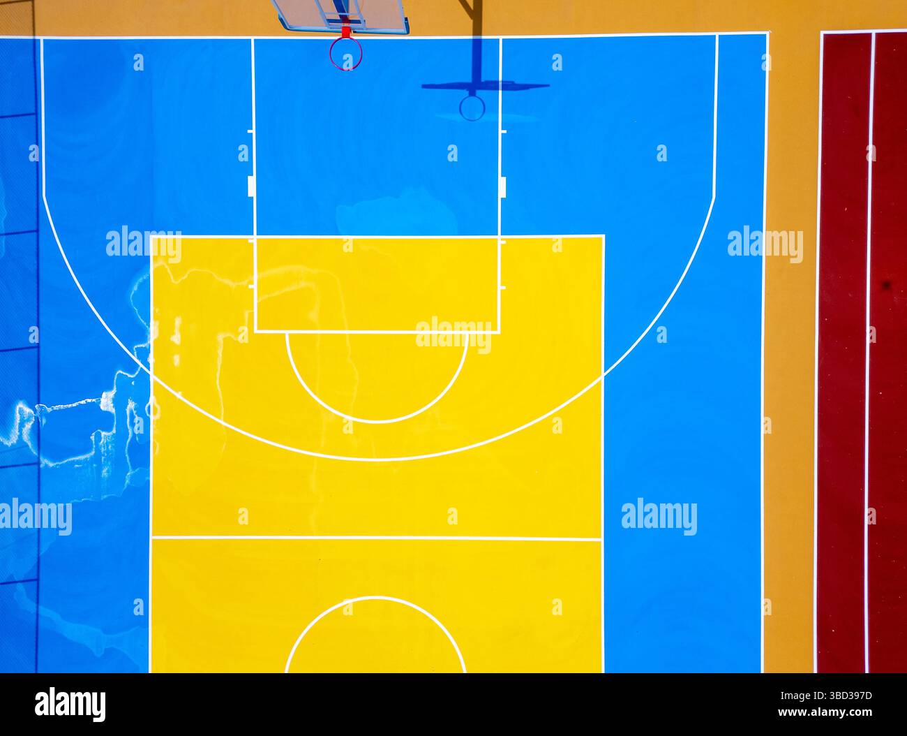 Aerial view of a colorful outdoor basketball court with vibrant blue ...