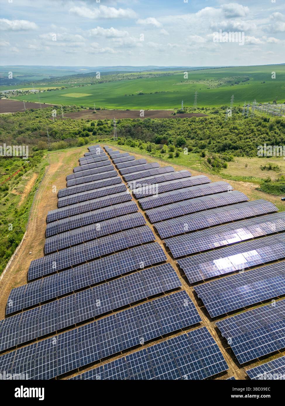Aerial view of a large solar power farm with rows of photovoltaic ...