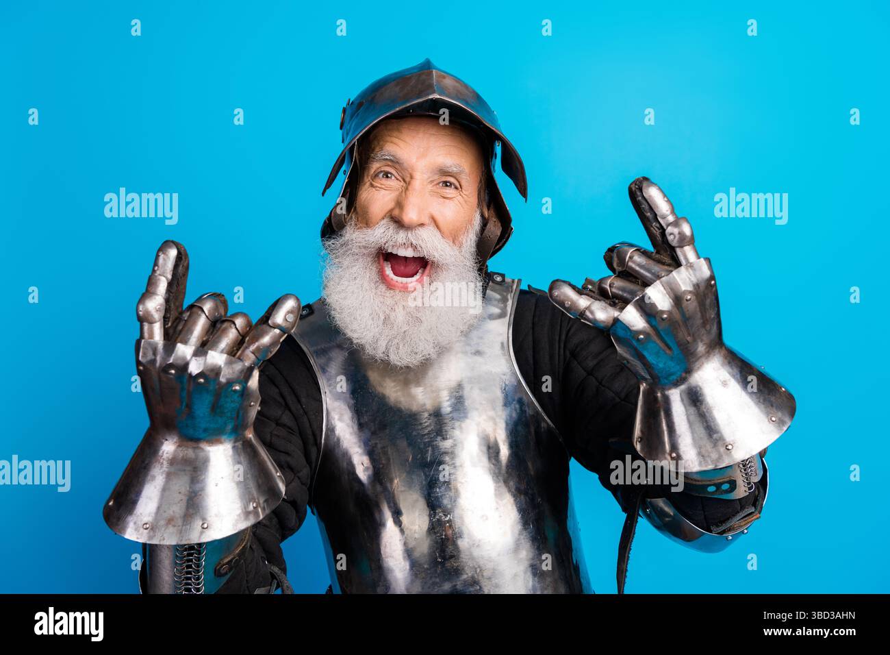 Elderly man dressed as a medieval knight, posing joyfully in armour ...