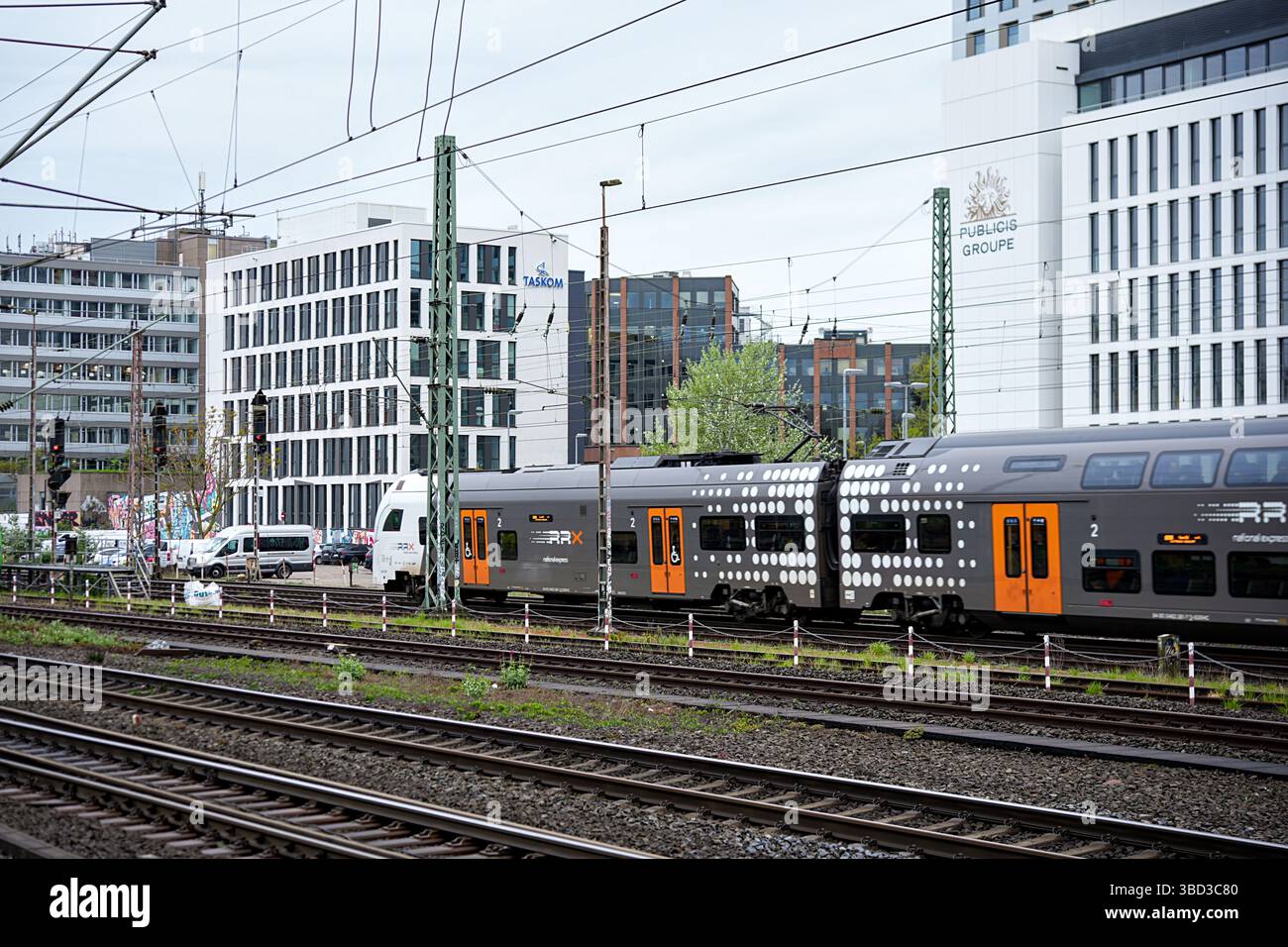 Dusseldorf, Germany 05.22.2025 Double decker commuter train moving past ...