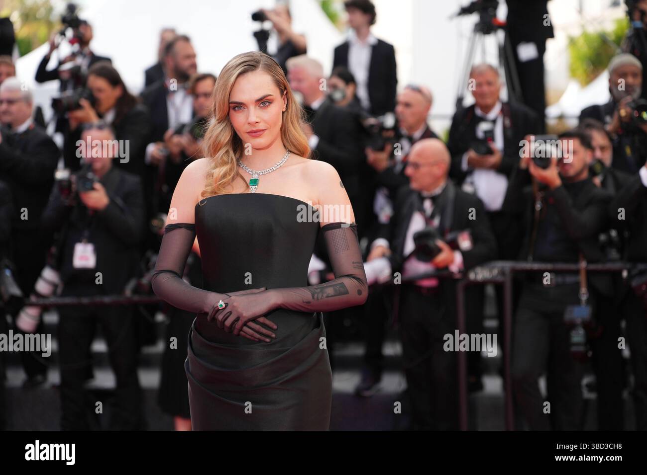 Cara Delevingne poses for photographers upon arrival at the premiere of ...