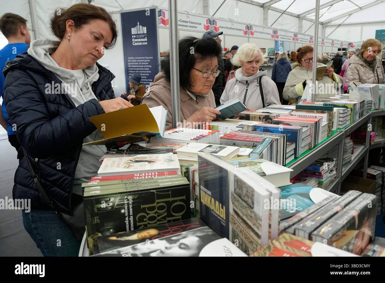Visitors choose books at an annual book festival in St. Petersburg ...