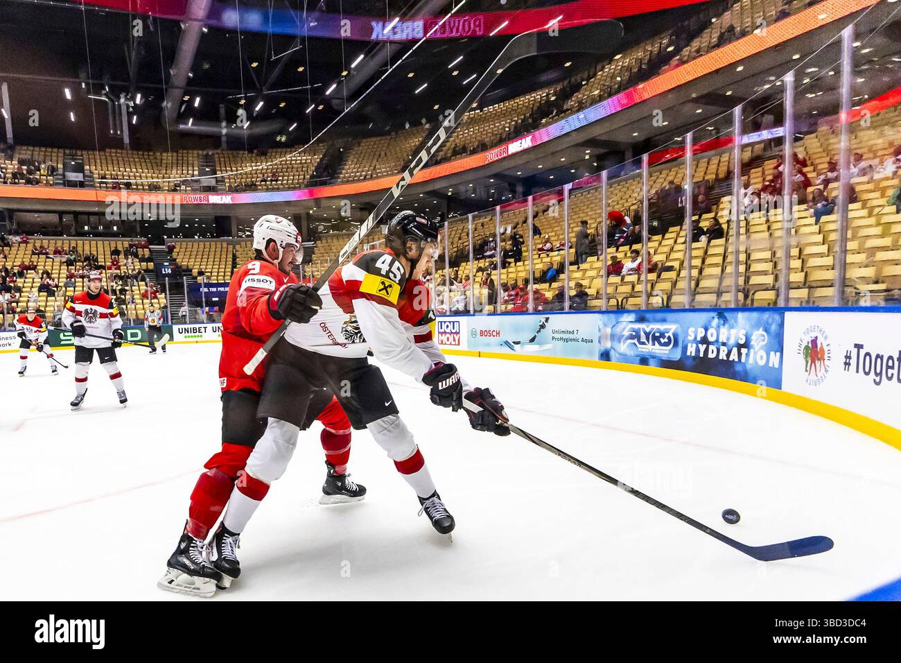 Switzerland's Damien Riat, left, and Austria's Gregor Biber in action during the IIHF 2025 World ...