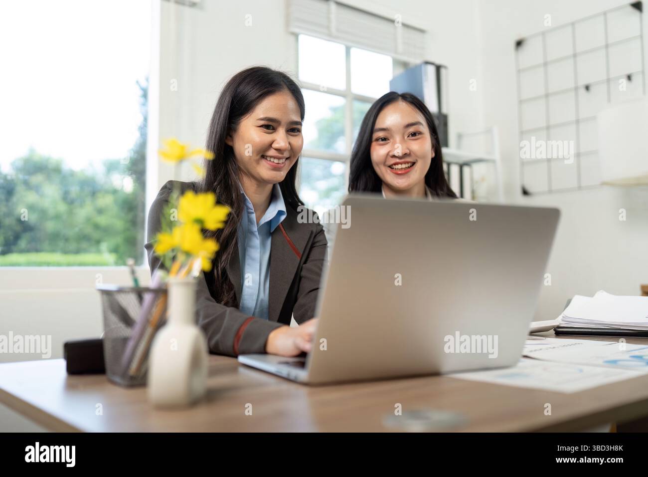 Professional Women Collaborating. Two female colleagues smiling while ...