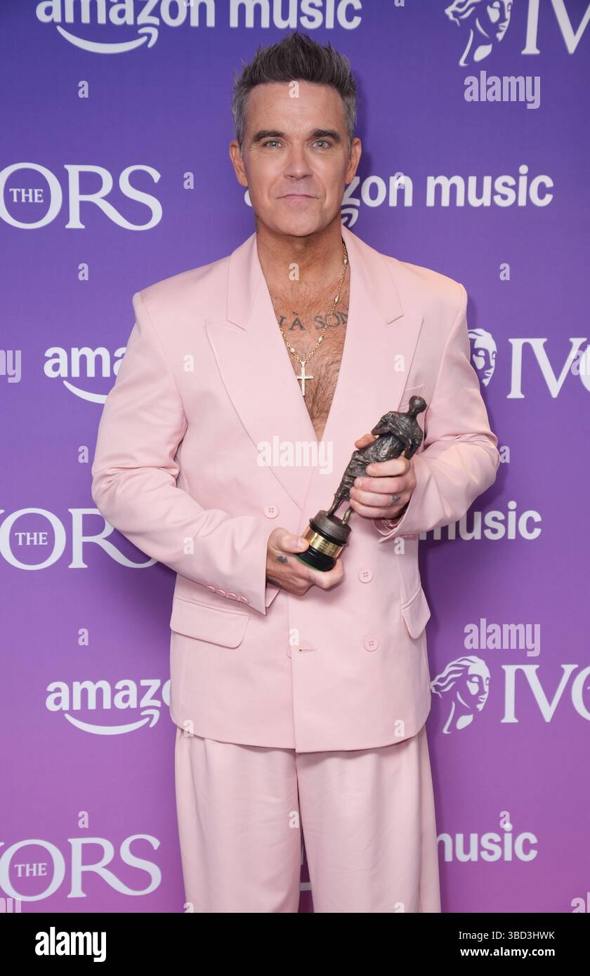 Robbie Williams, winner of the Icon Award, poses in the winners' room ...