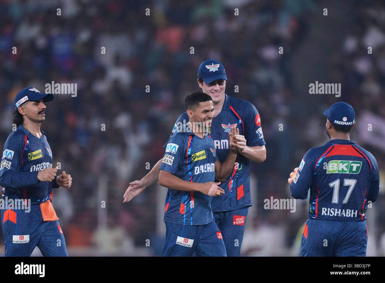 Lucknow Super Giants' Akash Singh, centre, celebrates with teammates ...