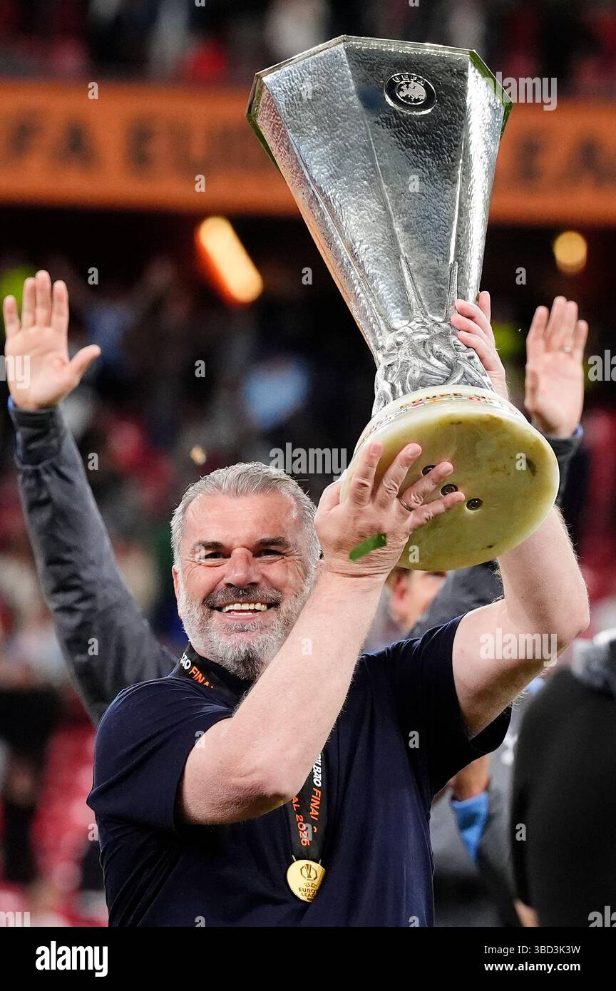 Tottenham Hotspur manager Ange Postecoglou celebrates with the trophy ...