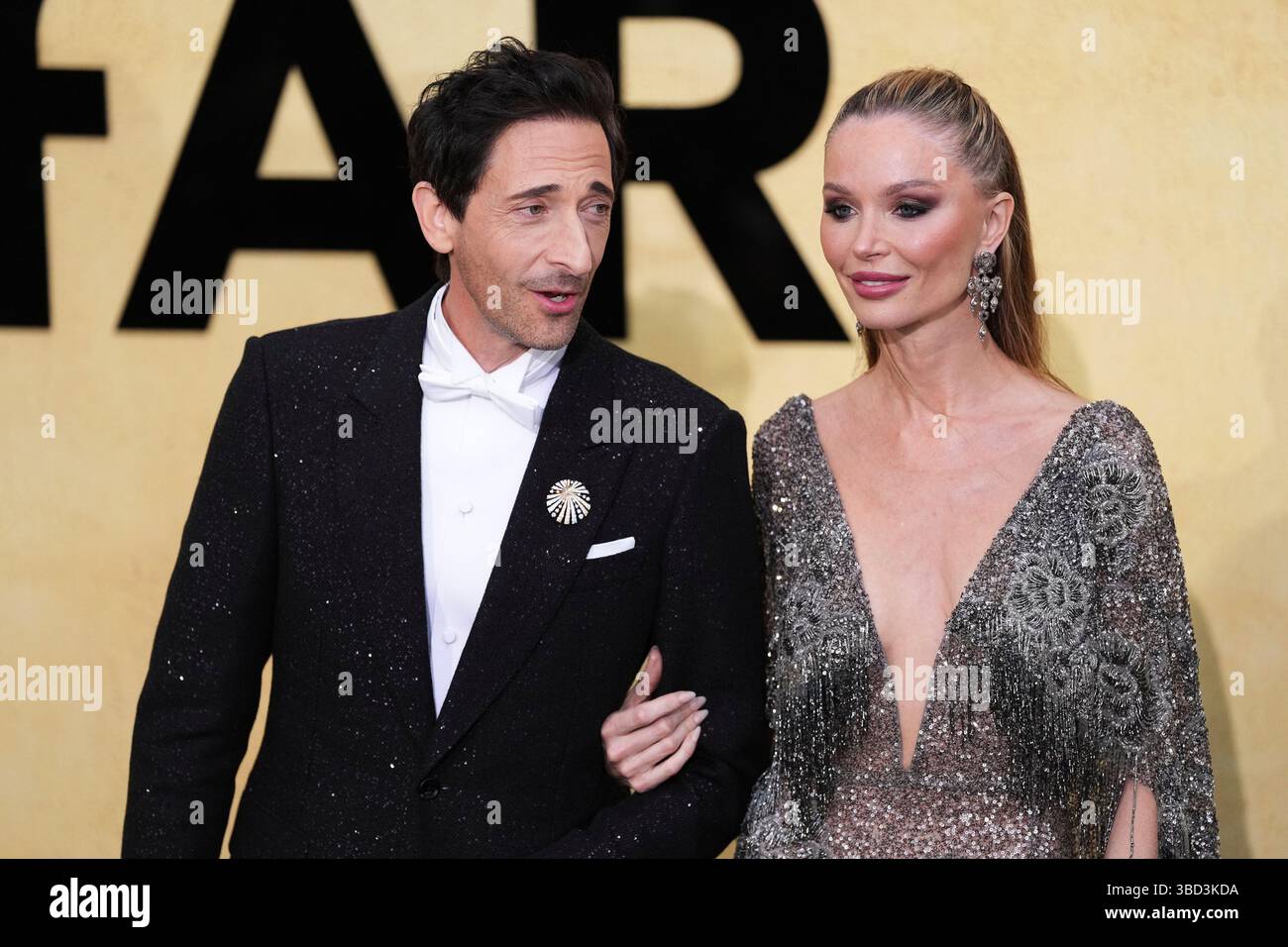 Adrien Brody, left, and Georgina Chapman pose for photographers upon ...