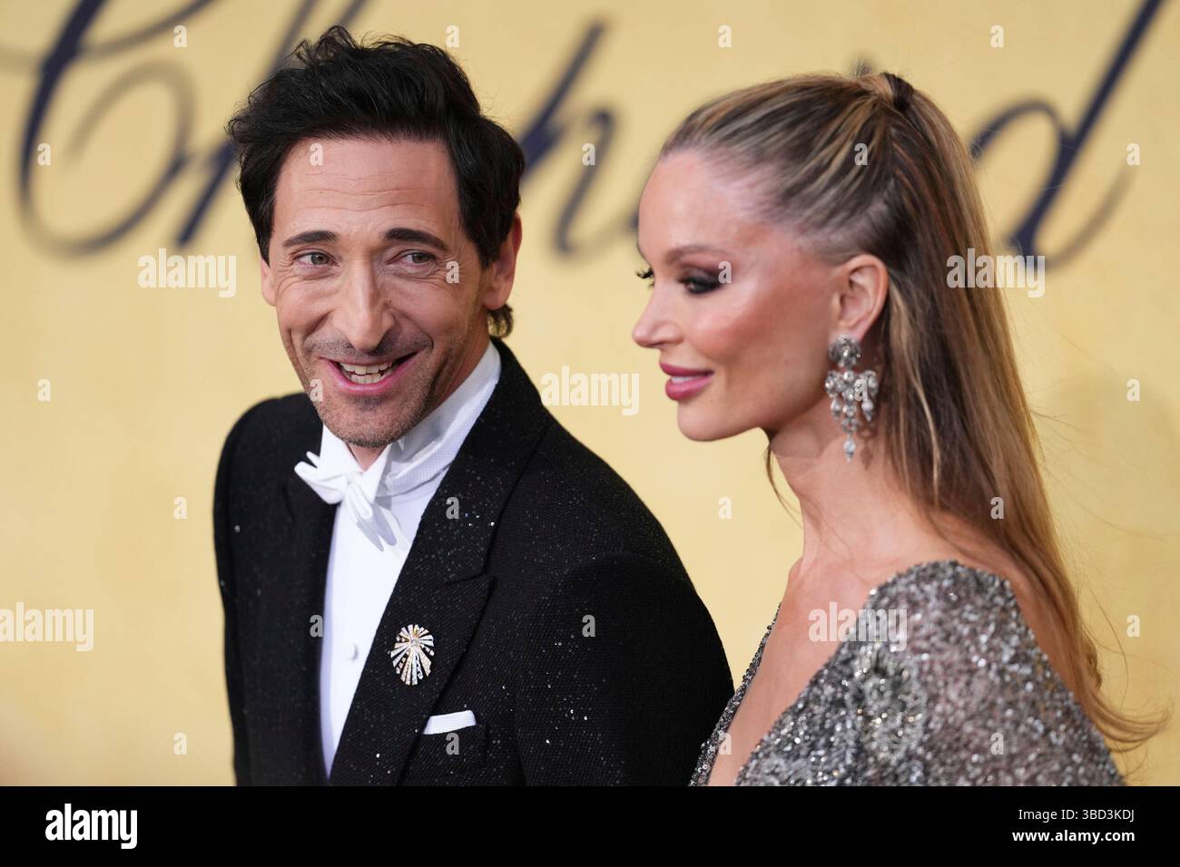 Adrien Brody, left, and Georgina Chapman pose for photographers upon ...