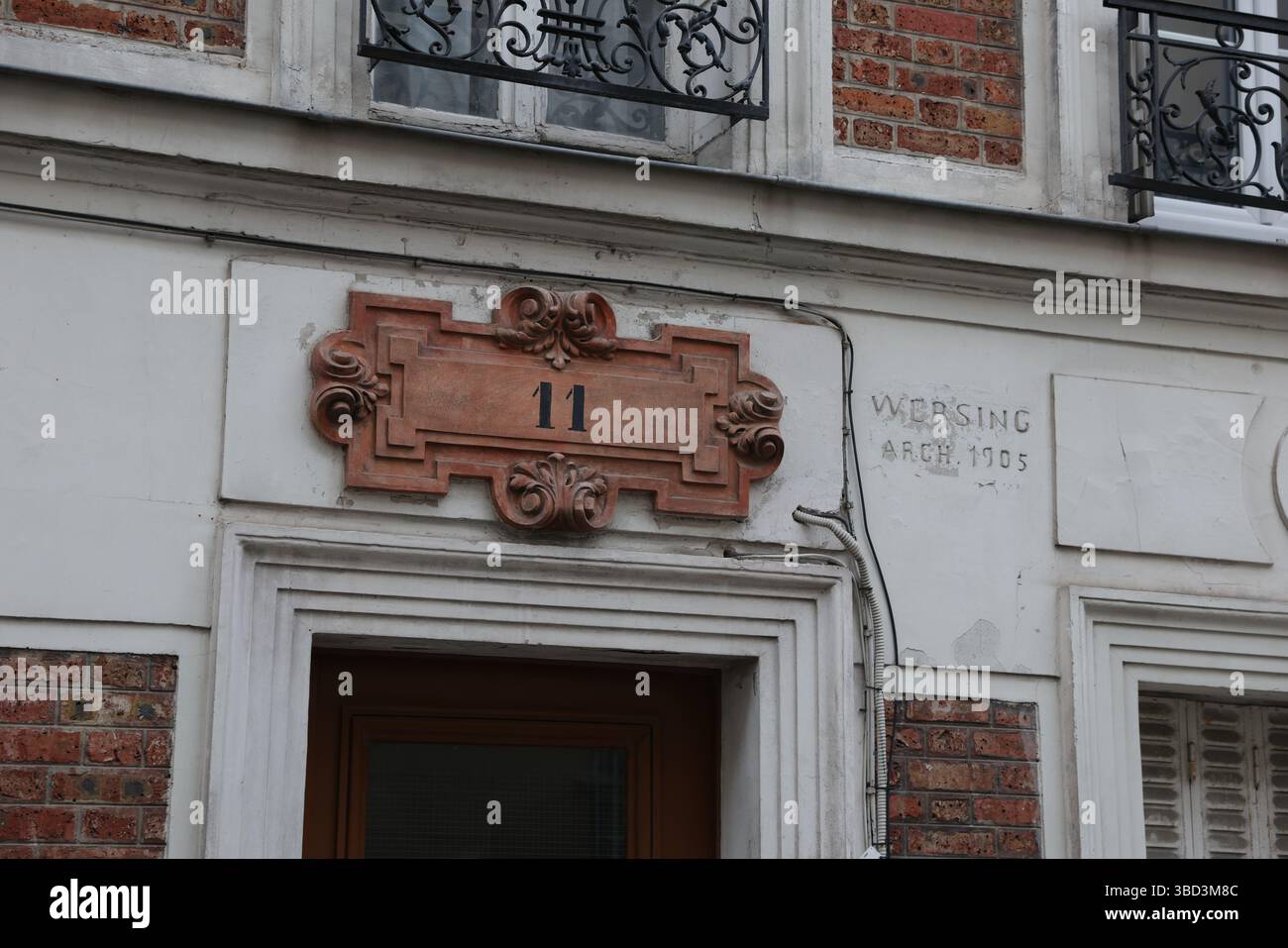 A beautifully preserved European building features an ornate plaque ...