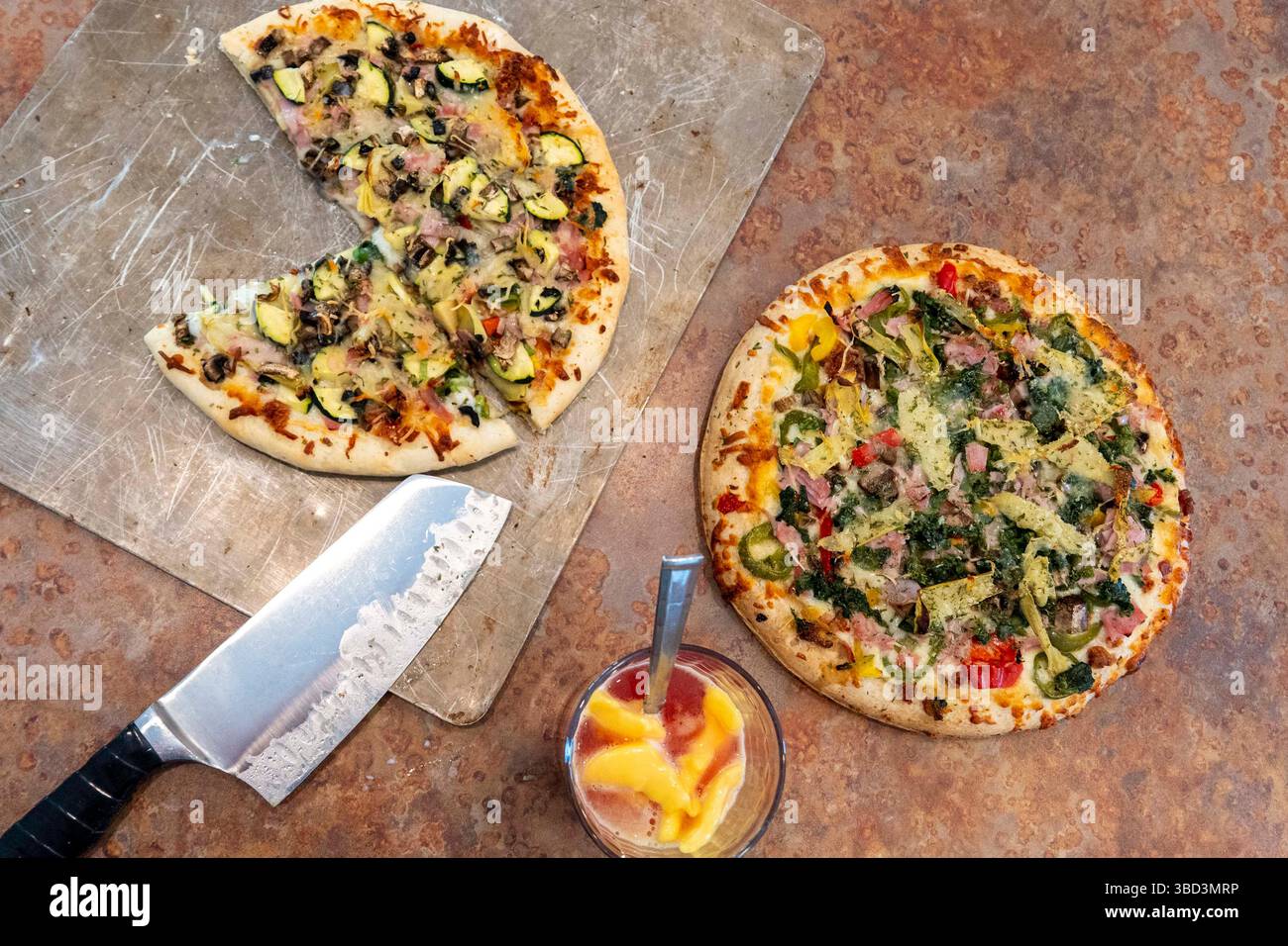 A pizza that has a slice taken out of it is currently resting on a ...